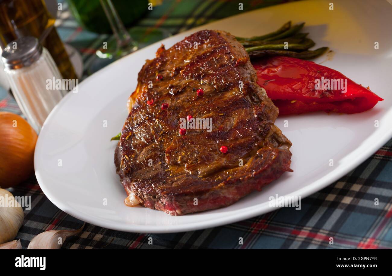 Spicy medium rare roasted veal entrecote with baked green beans and ...