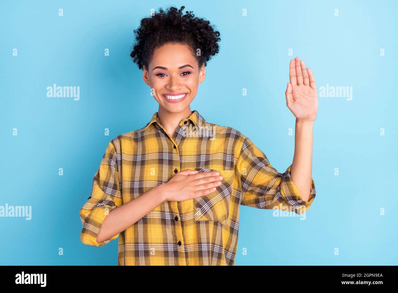 Photo portrait curly woman smiling giving oath isolated pastel blue ...