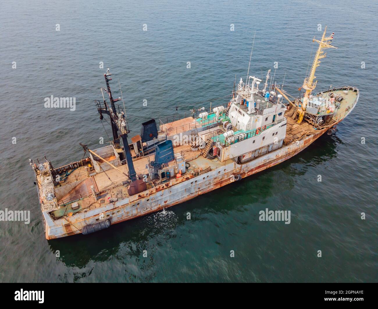 Old rusty ship at sea. Obsolescence of ships concept. Old ships pollute ...