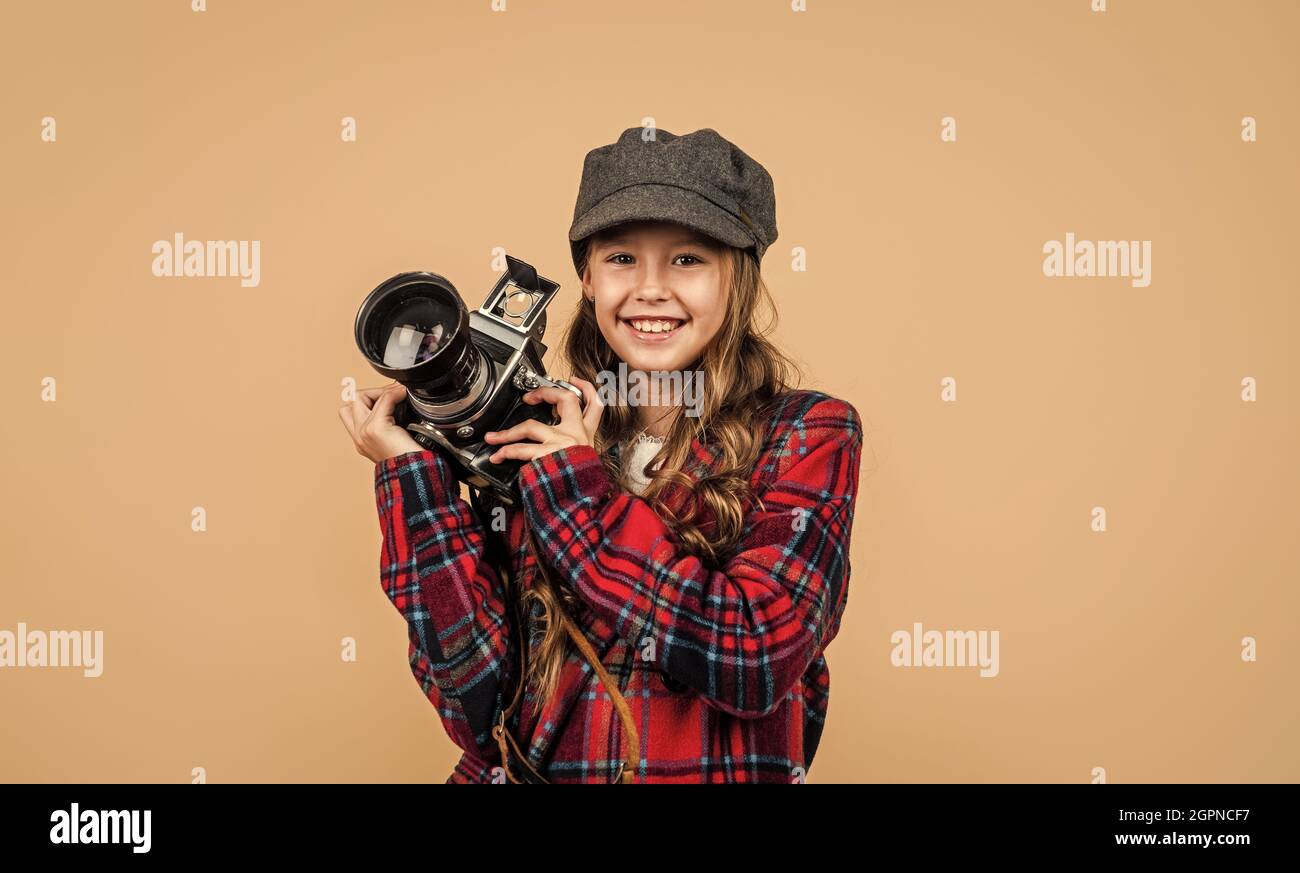 parisian retro look. french casual fashion. happy girl photographer in checkered jacket. spring ...