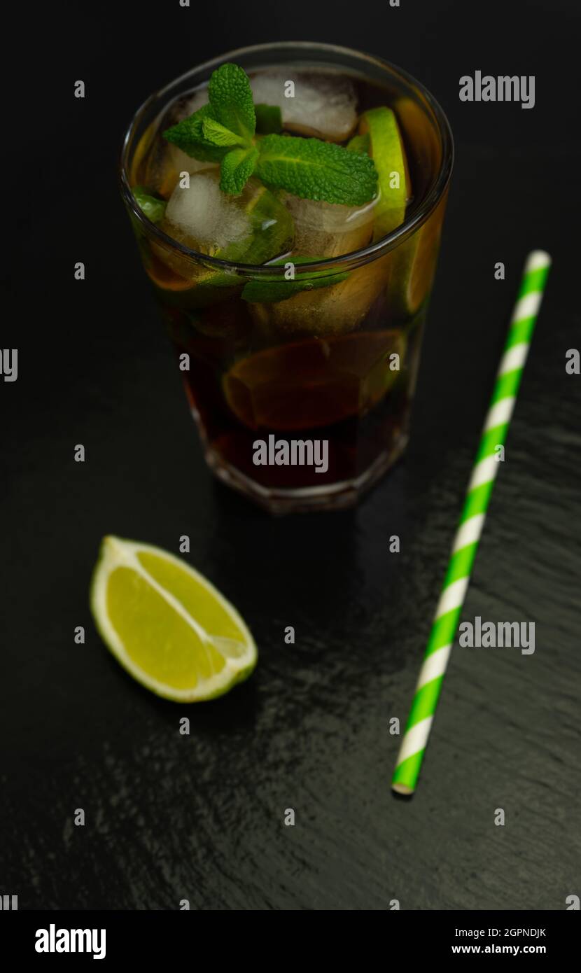 Cuba Libre cocktail with brown rum, lemon juice, cola and ice cubes ...