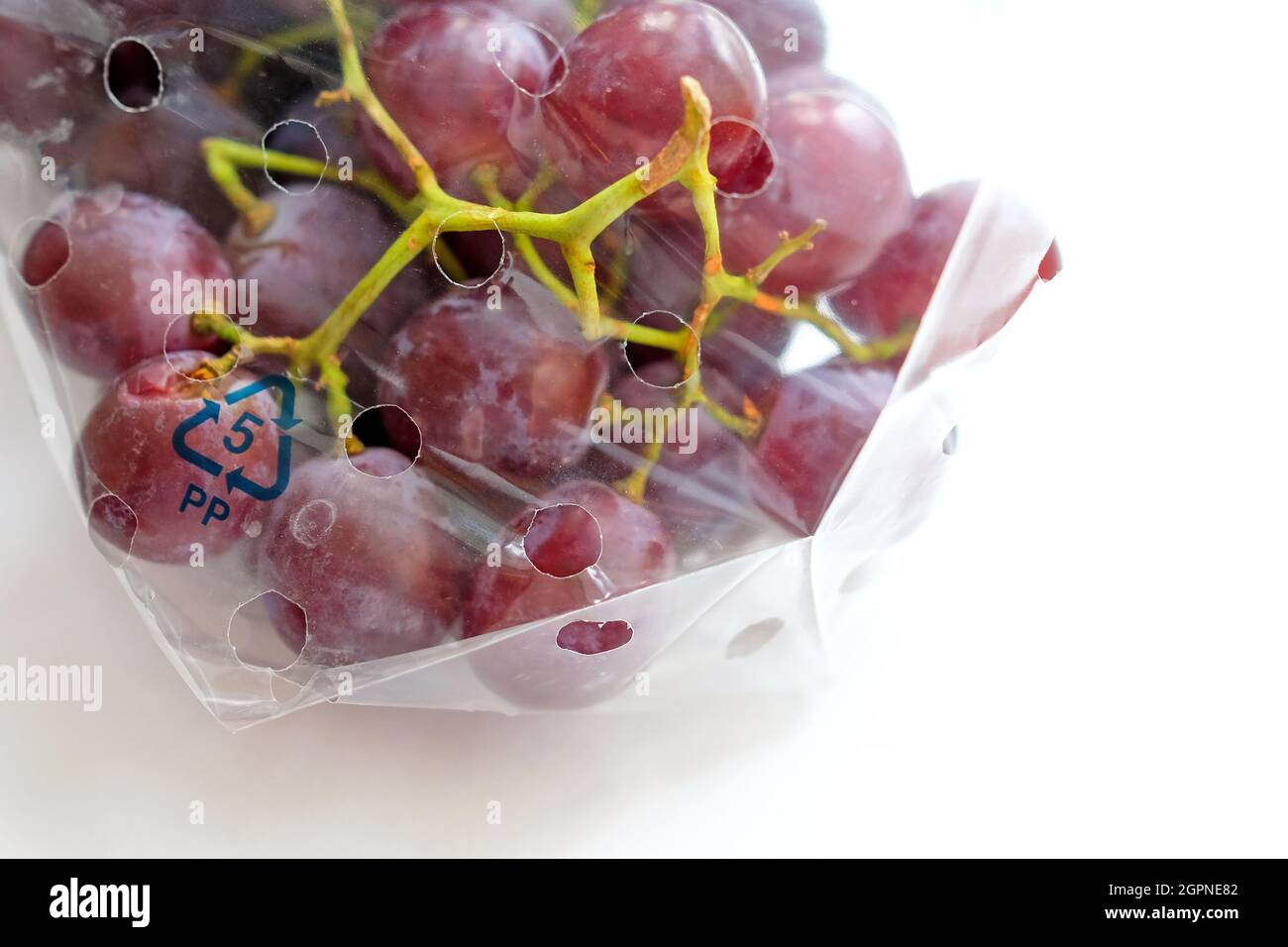 Large grapes in labeled packaging. On a light background Stock Photo ...
