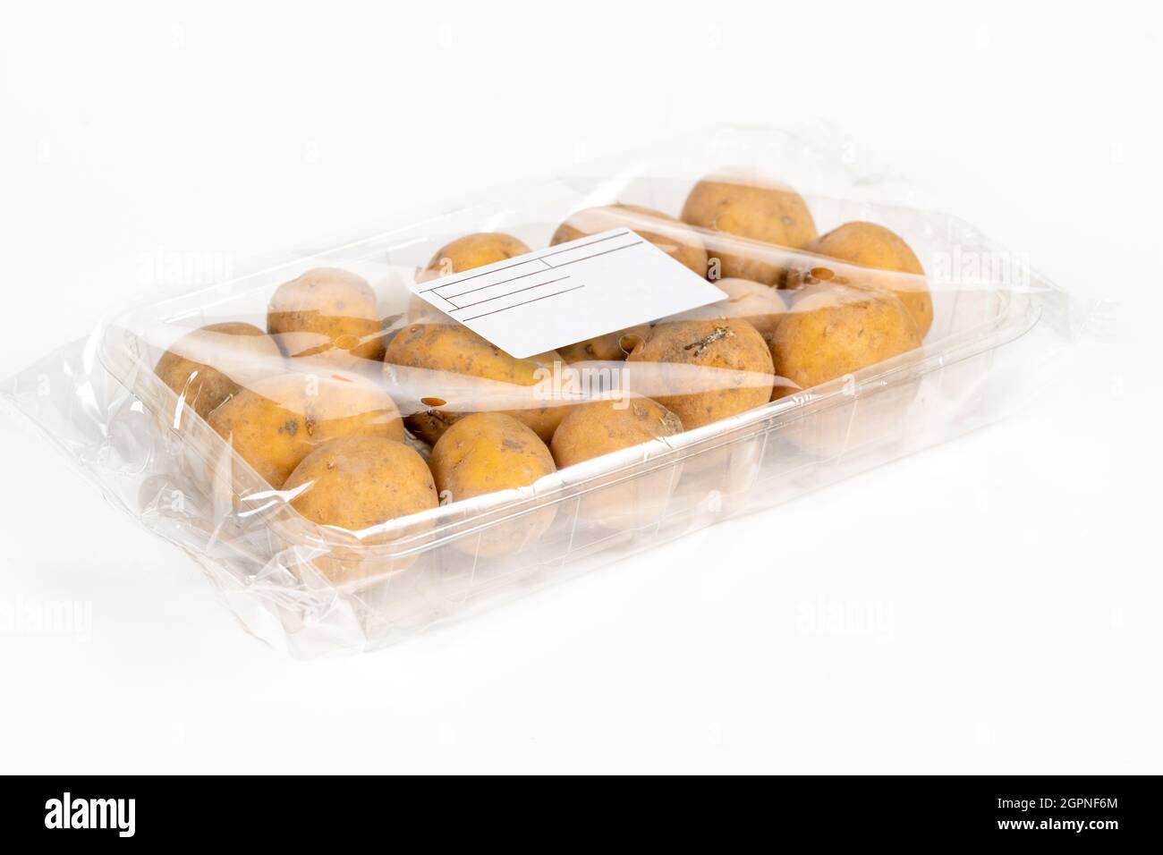 Freshly harvested potatoes in a labeled pack on white background Stock ...