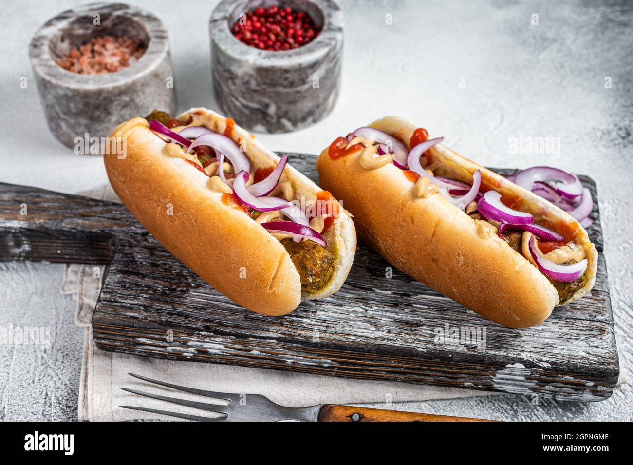 Vegetarian hot dog with with toppings and meatless sausage. White ...