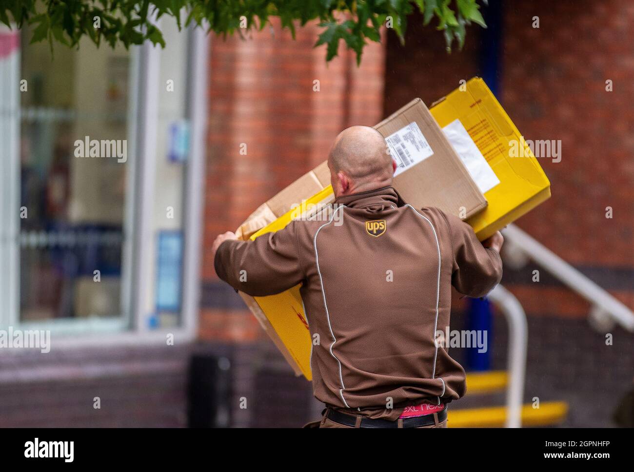 UPS parcel delivery driver carrying large boxes in Preston, Lancashire ...