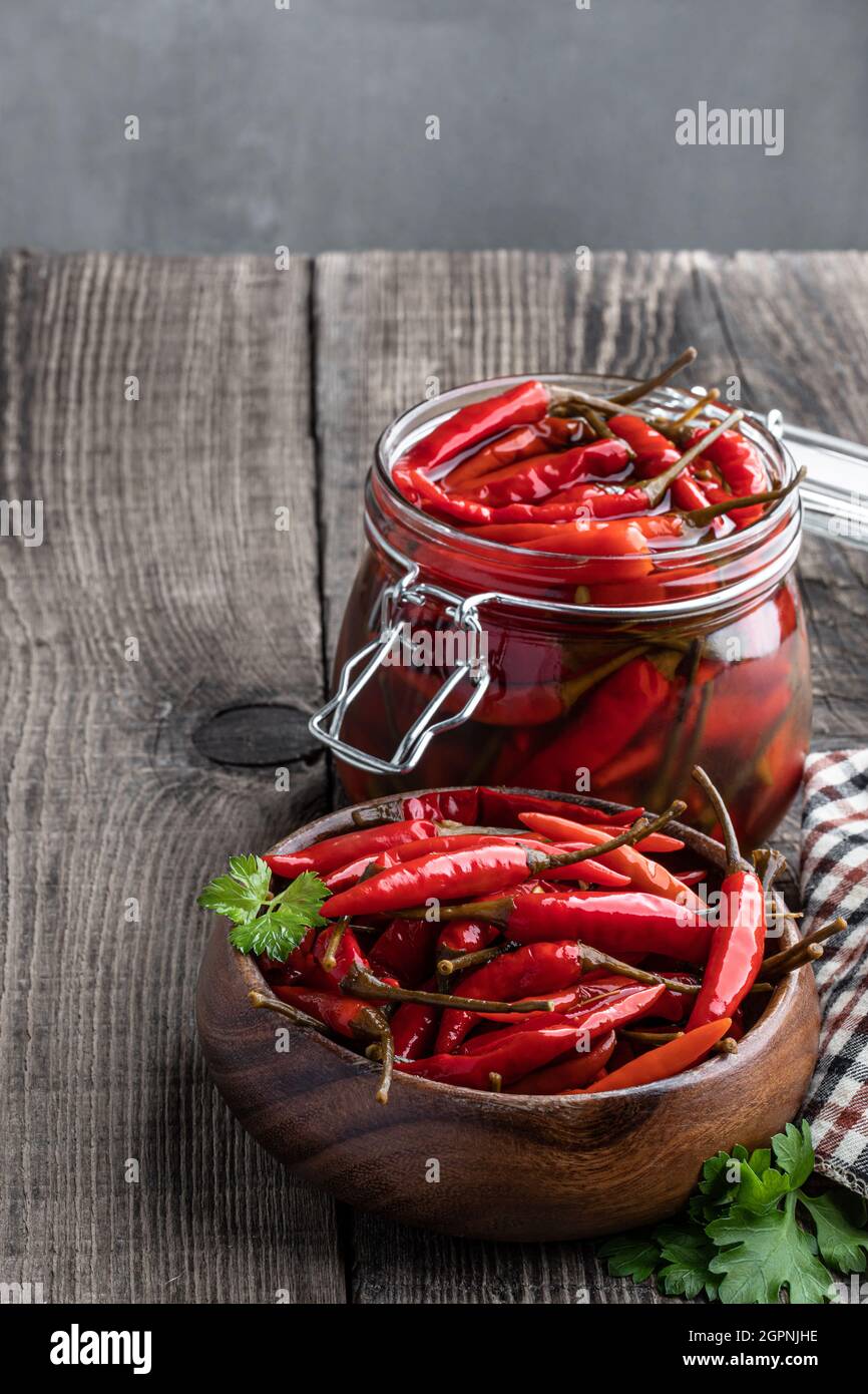 red spicy marinated pepper in wooden bowl on the rustic table Stock ...