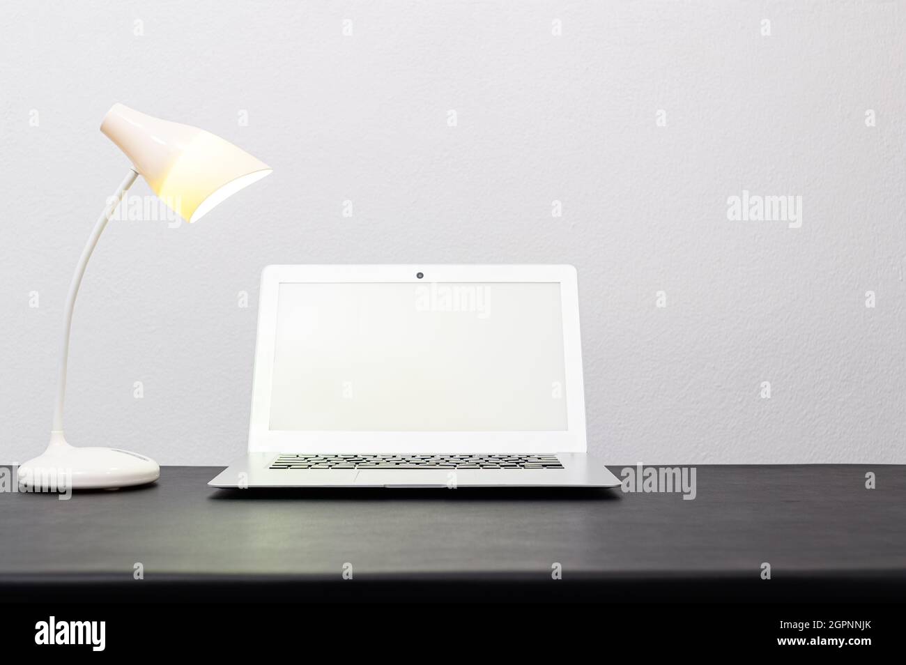 Notebook computers and lamps On the desk at the office Stock Photo - Alamy