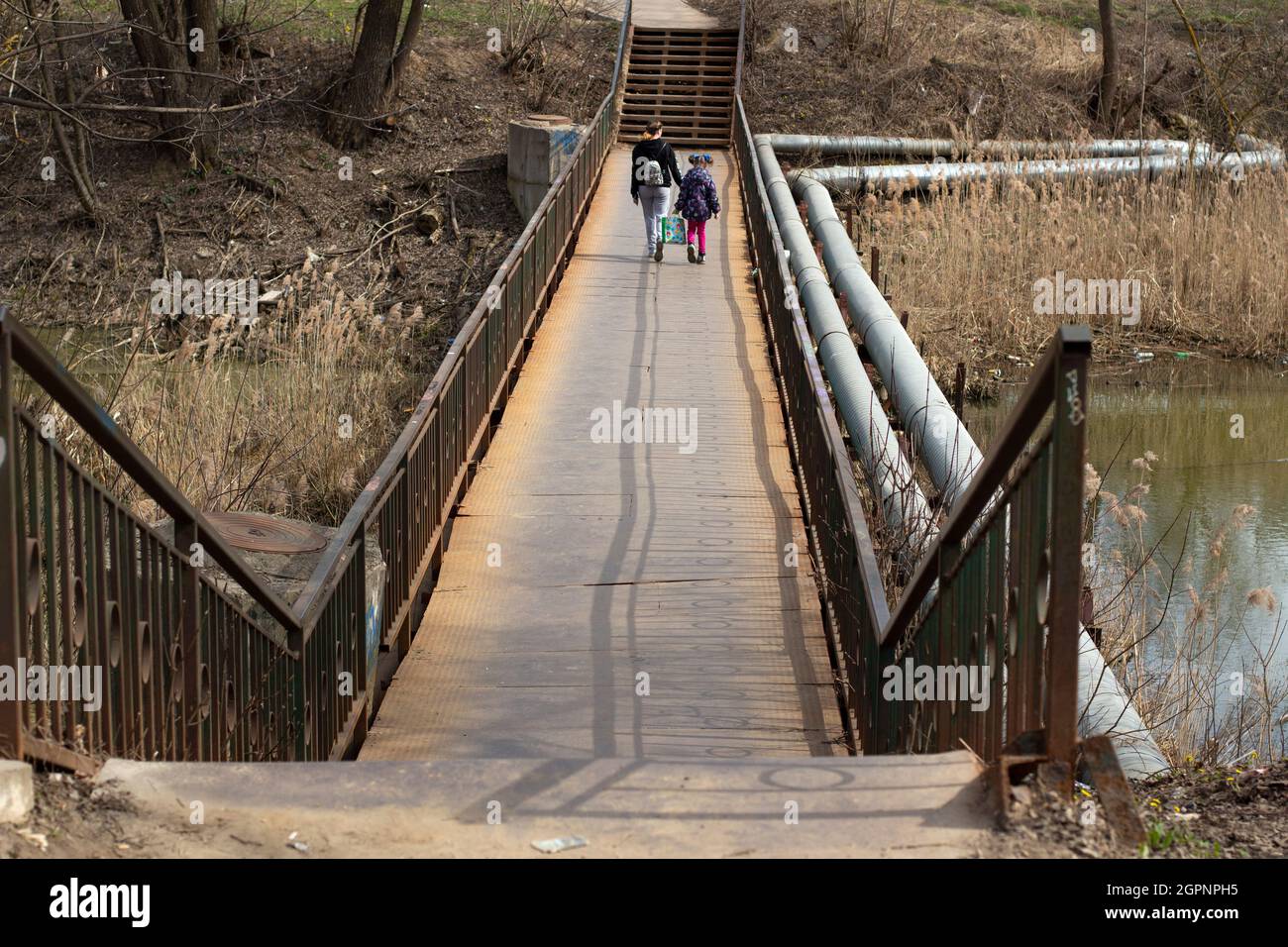 A bridge over the river. A pedestrian bridge over a body of water. It's ...