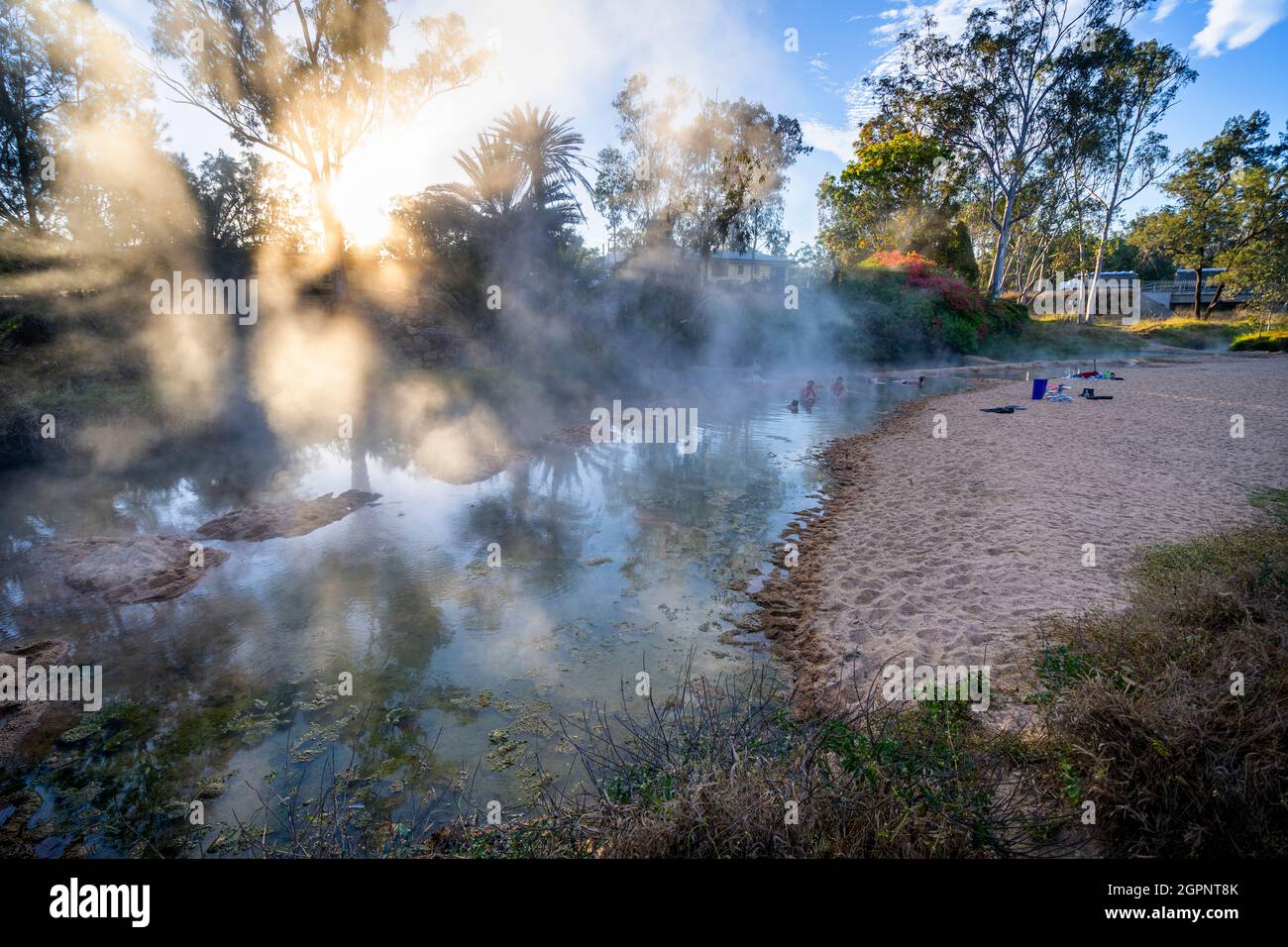 Steam rising at sunrise from the natural mineral hot water flowing in ...