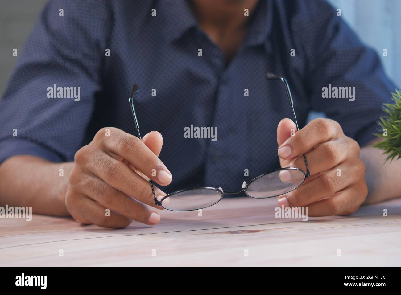 Close up of man hand holding old eyeglass Stock Photo - Alamy