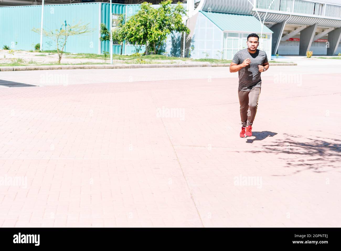 Man running on concrete road outdoors Stock Photo - Alamy