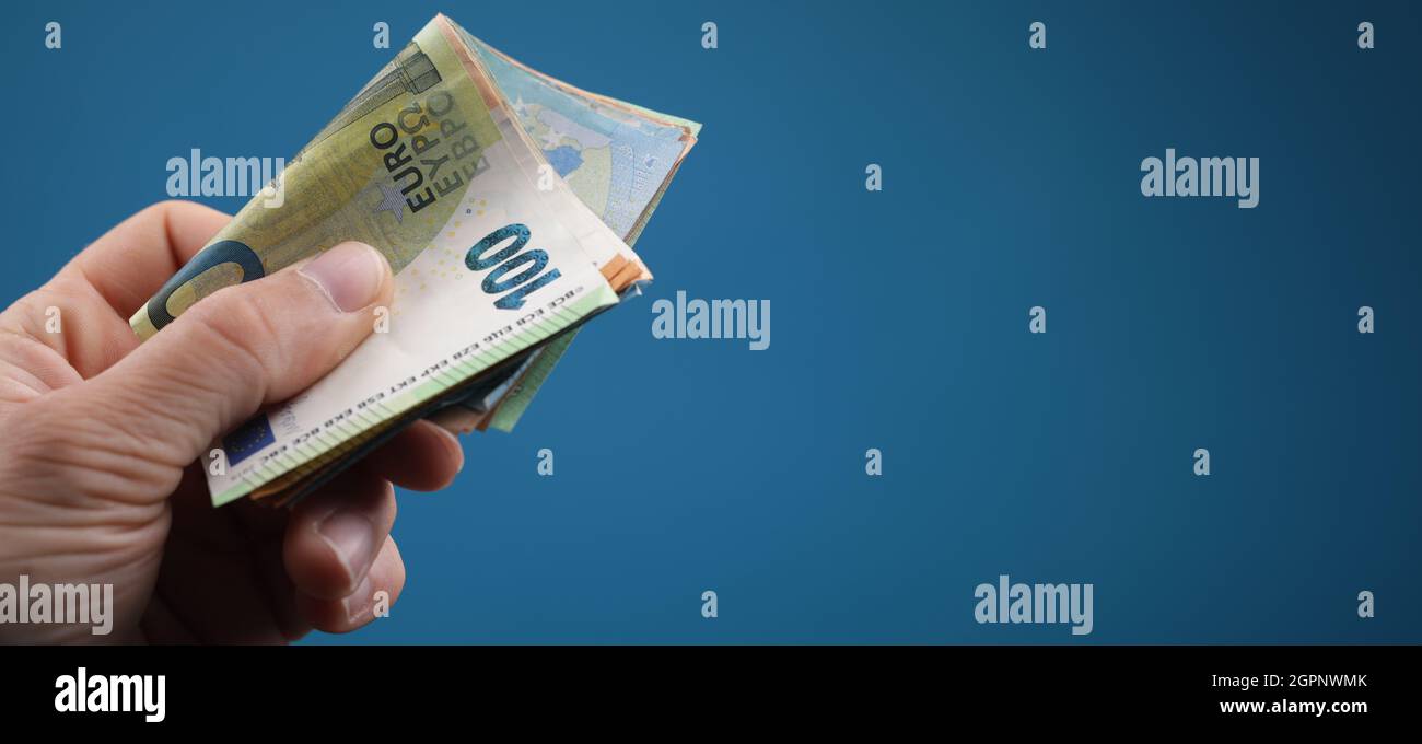 Euro banknotes in the blue background with copy space; banknotes of the ...