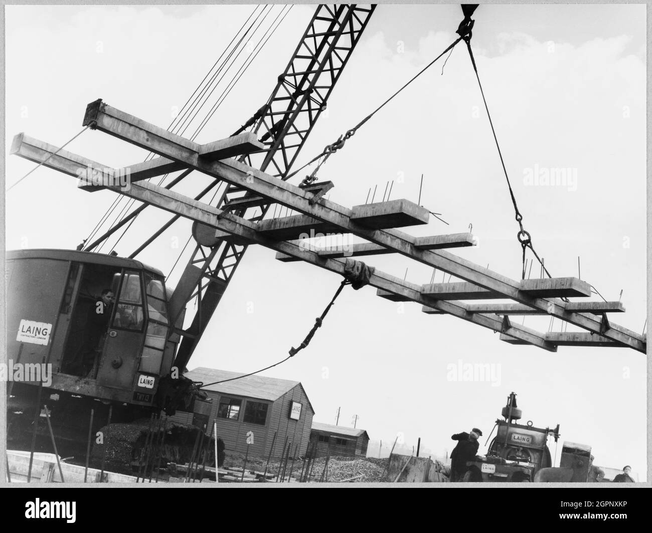 A crane lifting a precast 'H' frame from the casting bed, prior to ...
