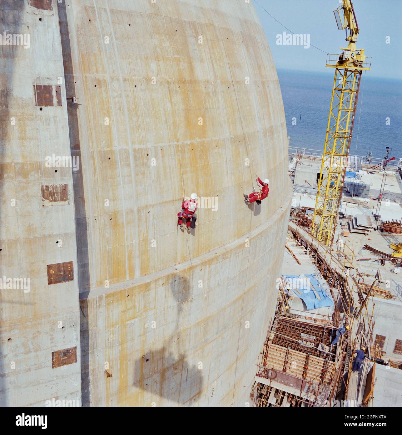 Two workers on the surface of the reactor dome at Sizewell 'B' Nuclear ...
