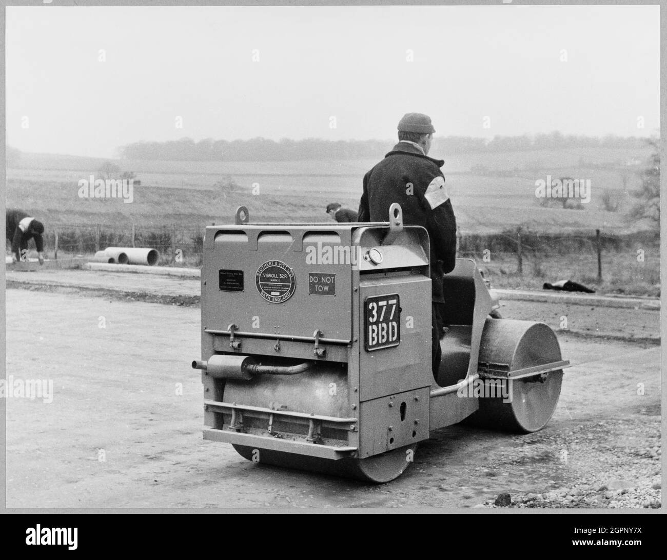 A worker driving a Stothert & Pitt 'Vibroll' 32R Mk1 machine, a ...