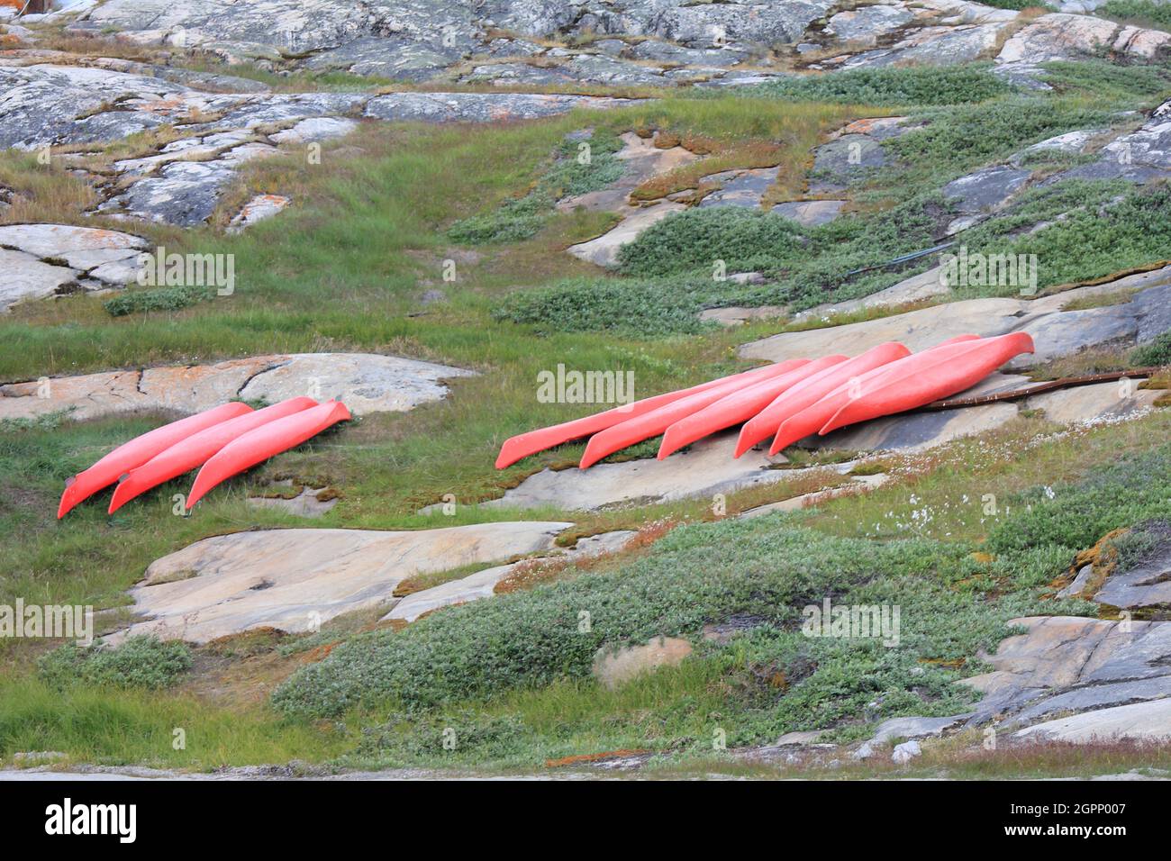 Red kayaks ashore in arctic landscape Stock Photo - Alamy