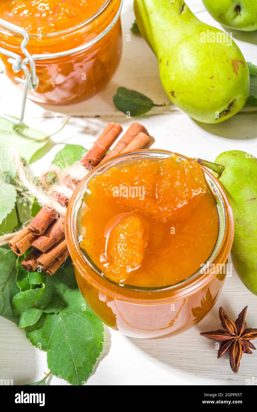 Homemade golden colored pear jam, with farm pears and leaves on white ...