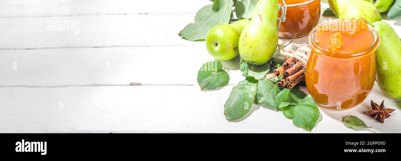Homemade golden colored pear jam, with farm pears and leaves on white ...