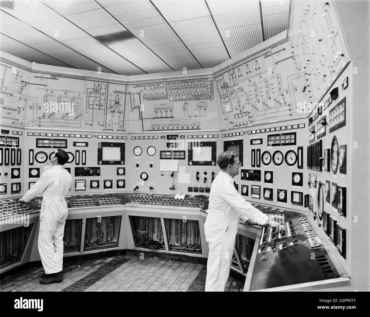 Two workers operating the electronic console panel at the Whitbread ...