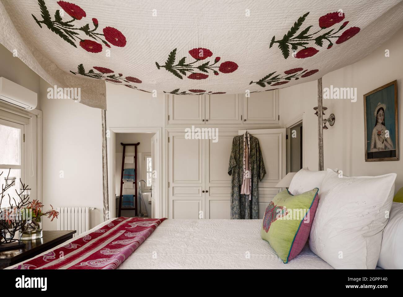 Floral canopy with red kantha throw on Goan four poster bed in Spanish ...