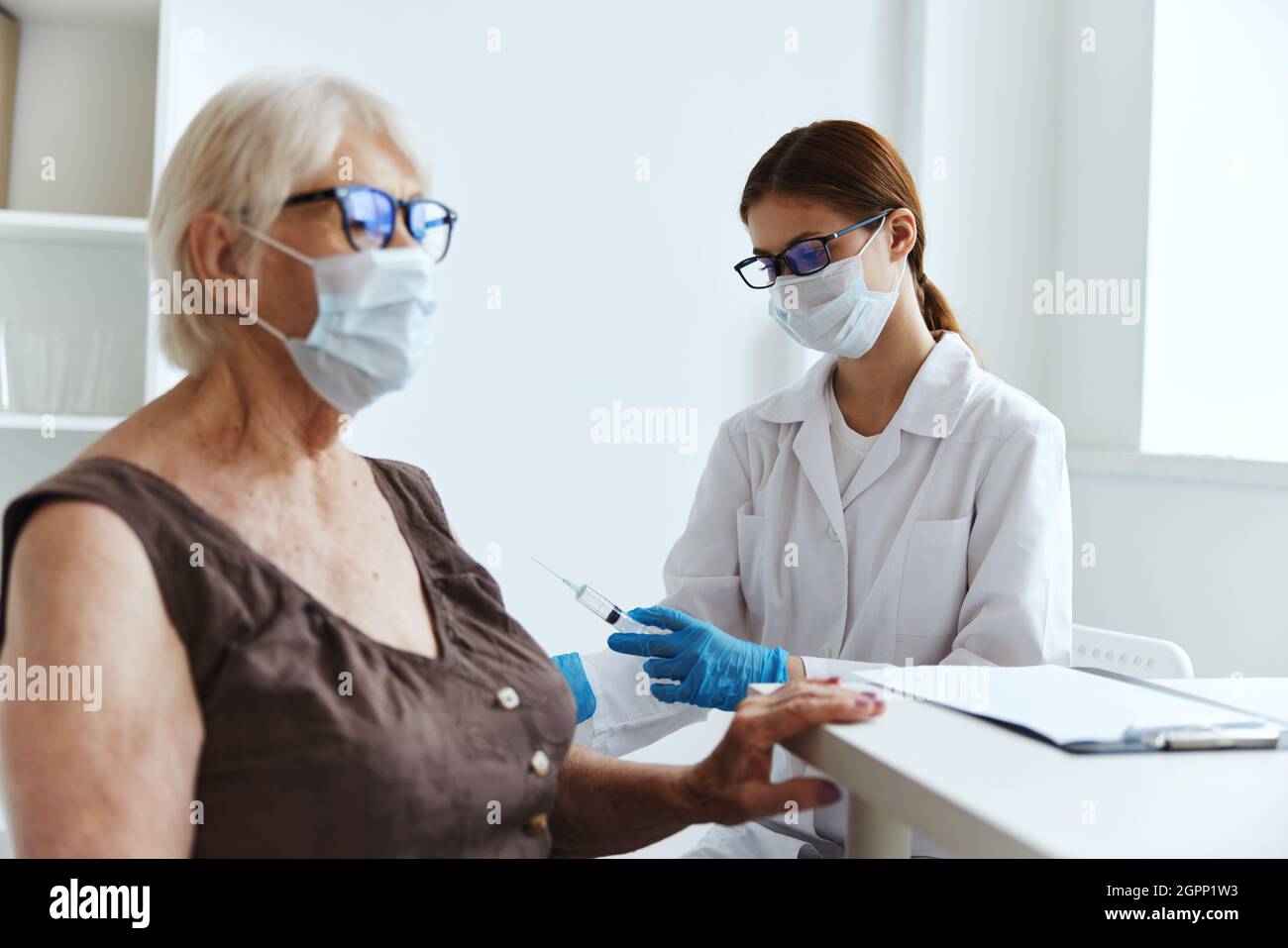 doctor with a syringe makes an injection in the arm health care Stock ...