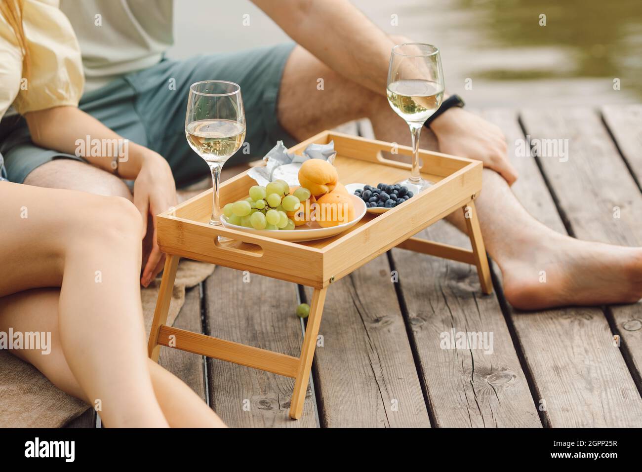 Wonderful moments of relaxation on summer picnic with wine, fruit and ...