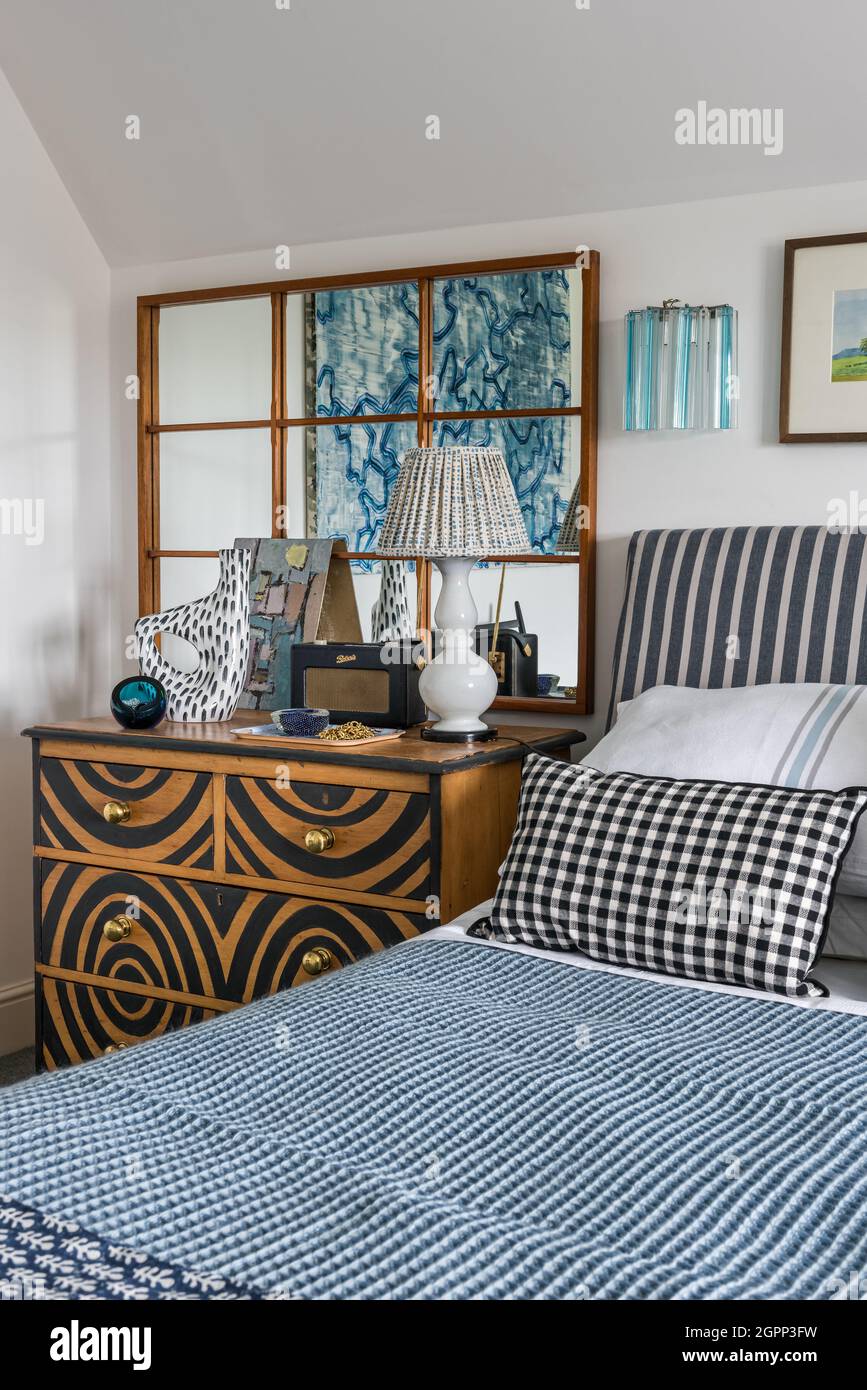 Mirror panel on painted chests in Sussex bedroom, UK Stock Photo - Alamy