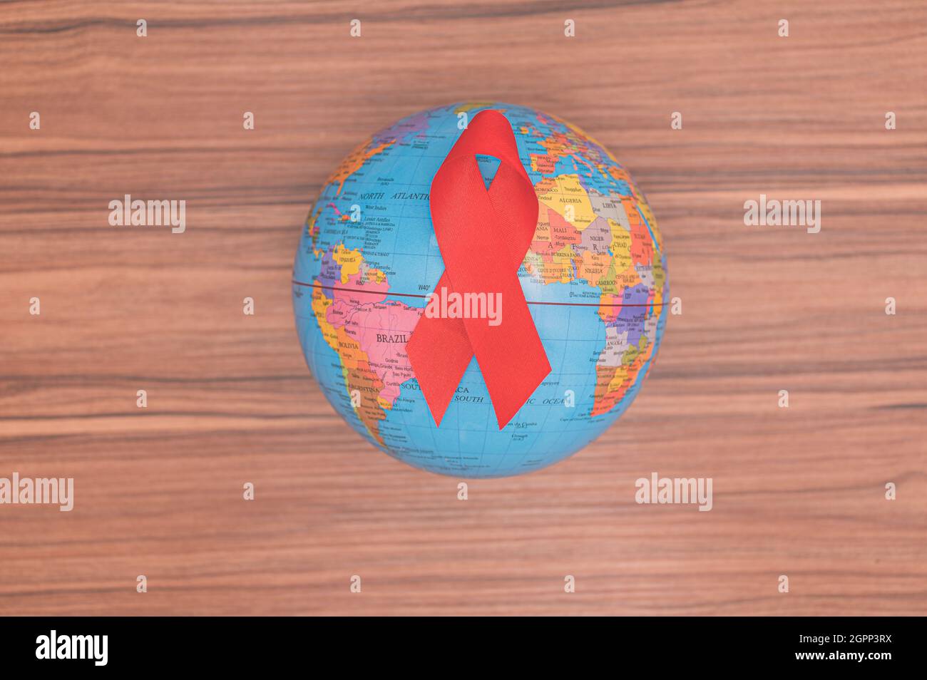 Red ribbon symbolizes world health day Stock Photo - Alamy
