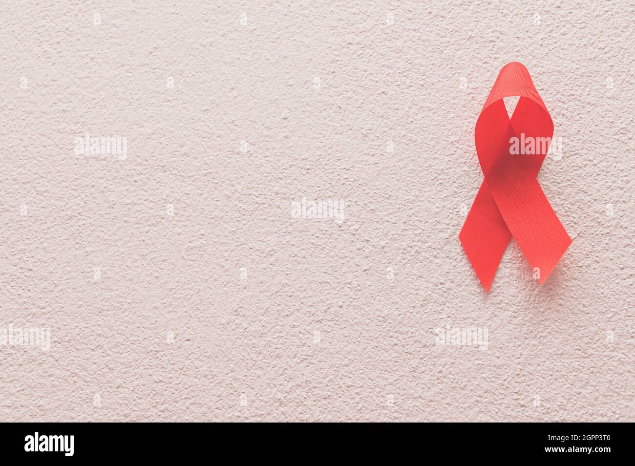 Red ribbon symbolizes world health day Stock Photo - Alamy