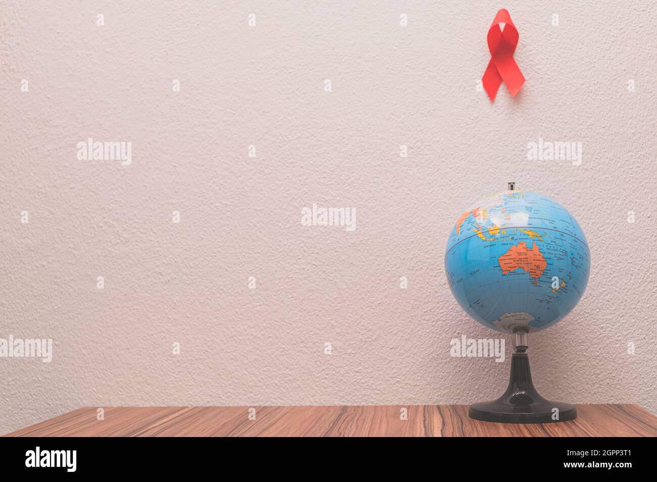 Red ribbon symbolizes world health day Stock Photo - Alamy