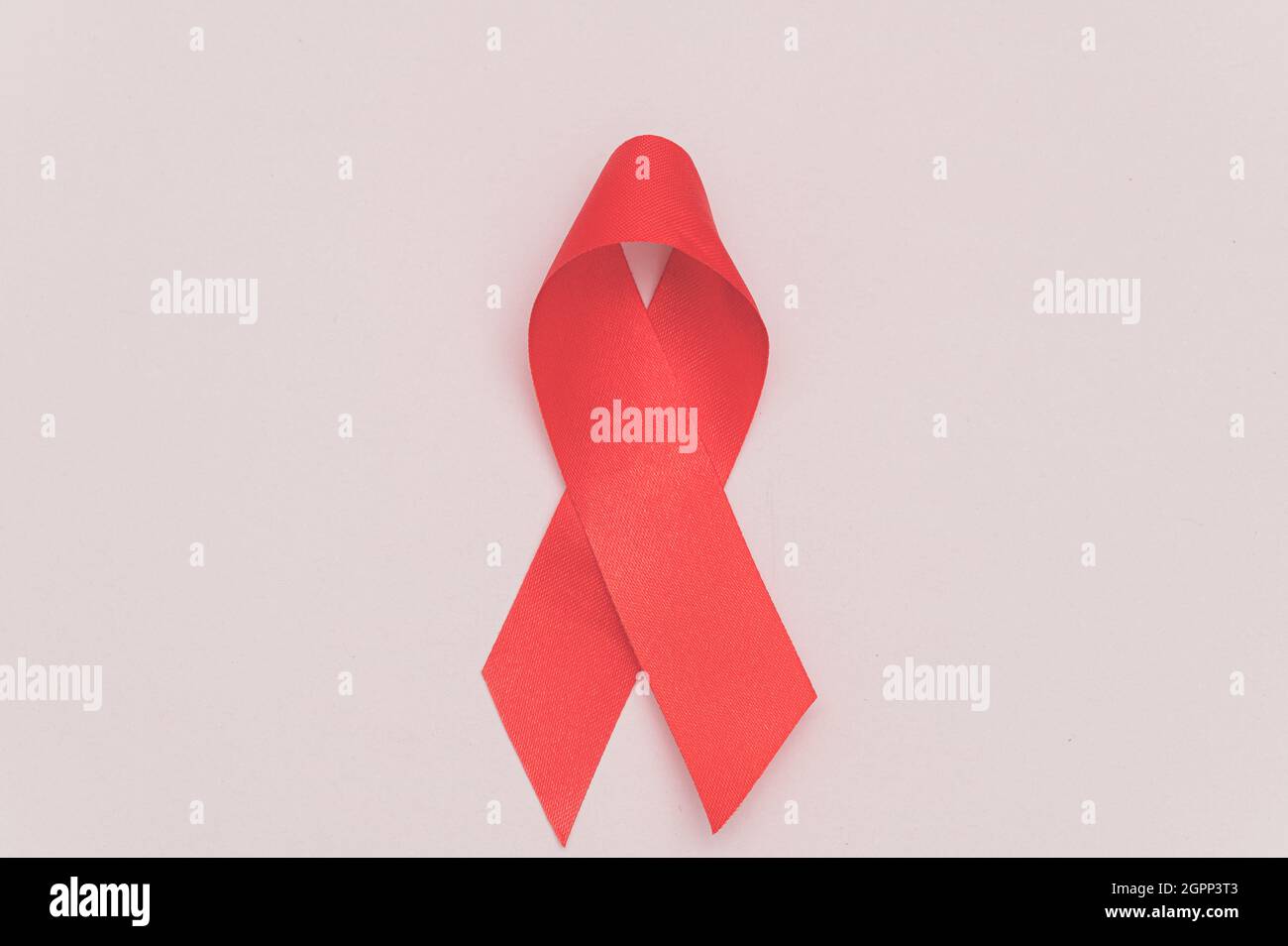 Red ribbon symbolizes world health day Stock Photo - Alamy