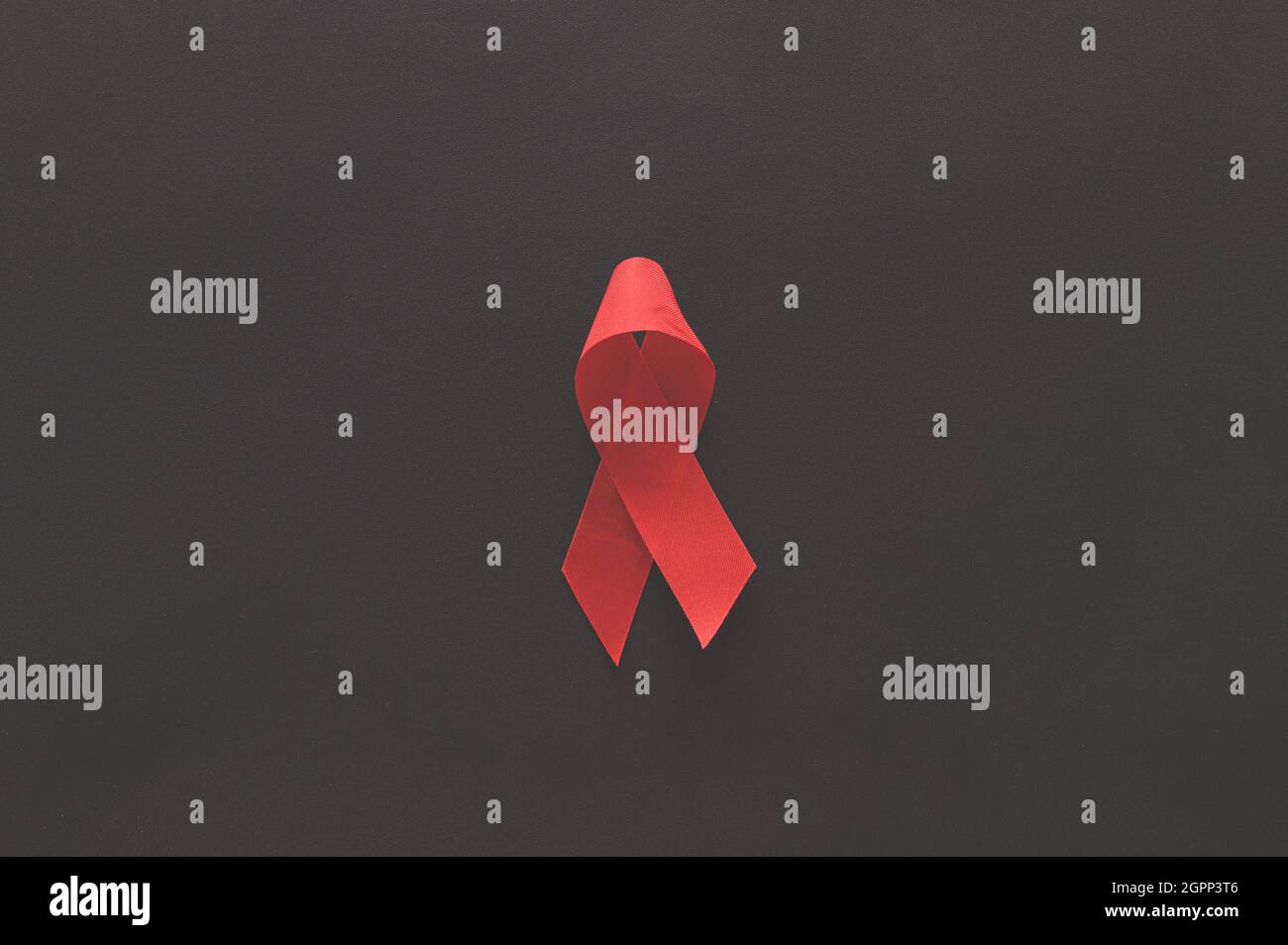Red ribbon symbolizes world health day Stock Photo - Alamy
