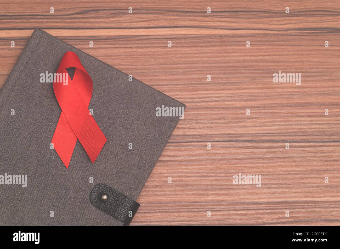Red ribbon symbolizes world health day Stock Photo - Alamy