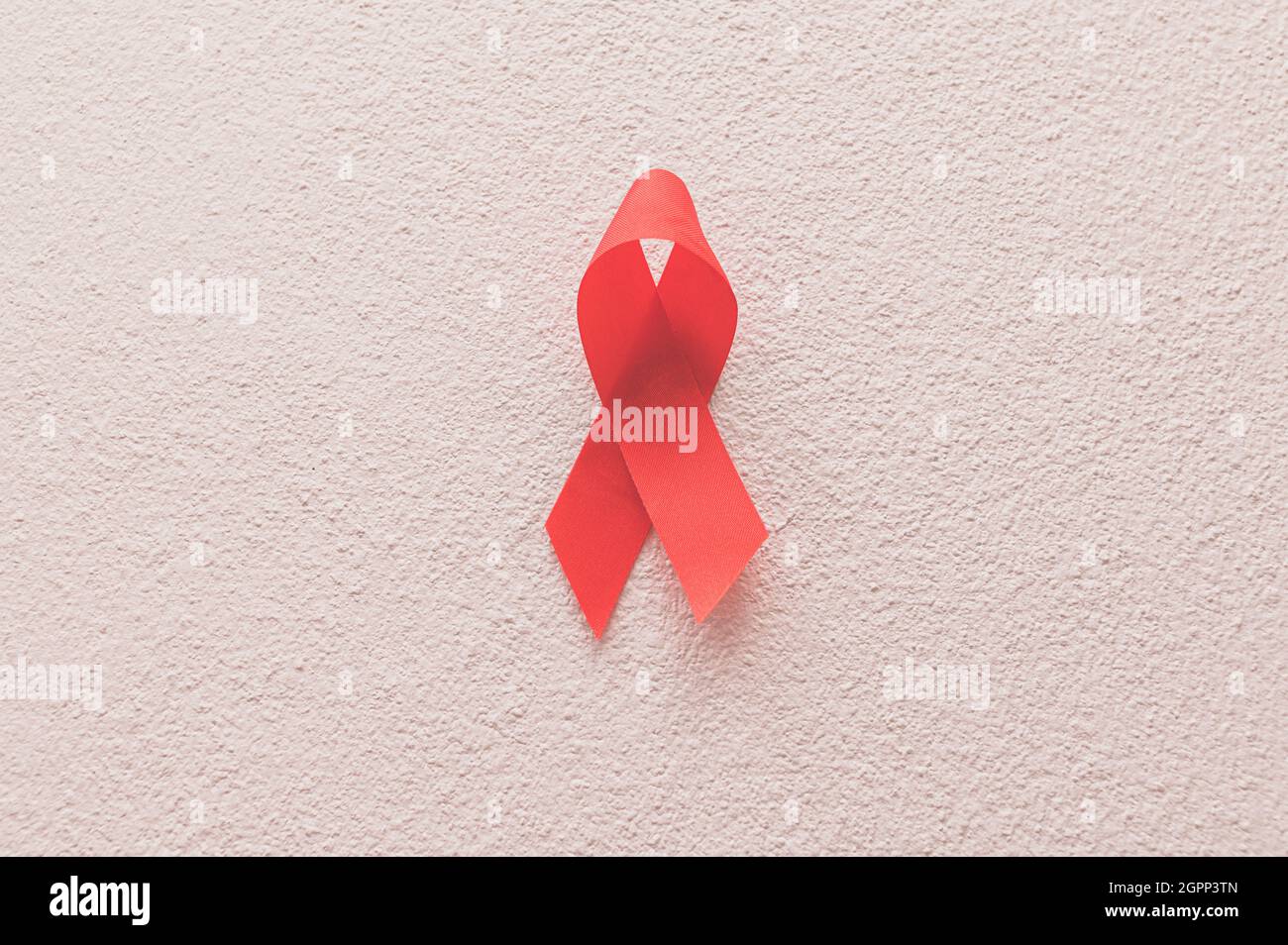 Red ribbon symbolizes world health day Stock Photo - Alamy