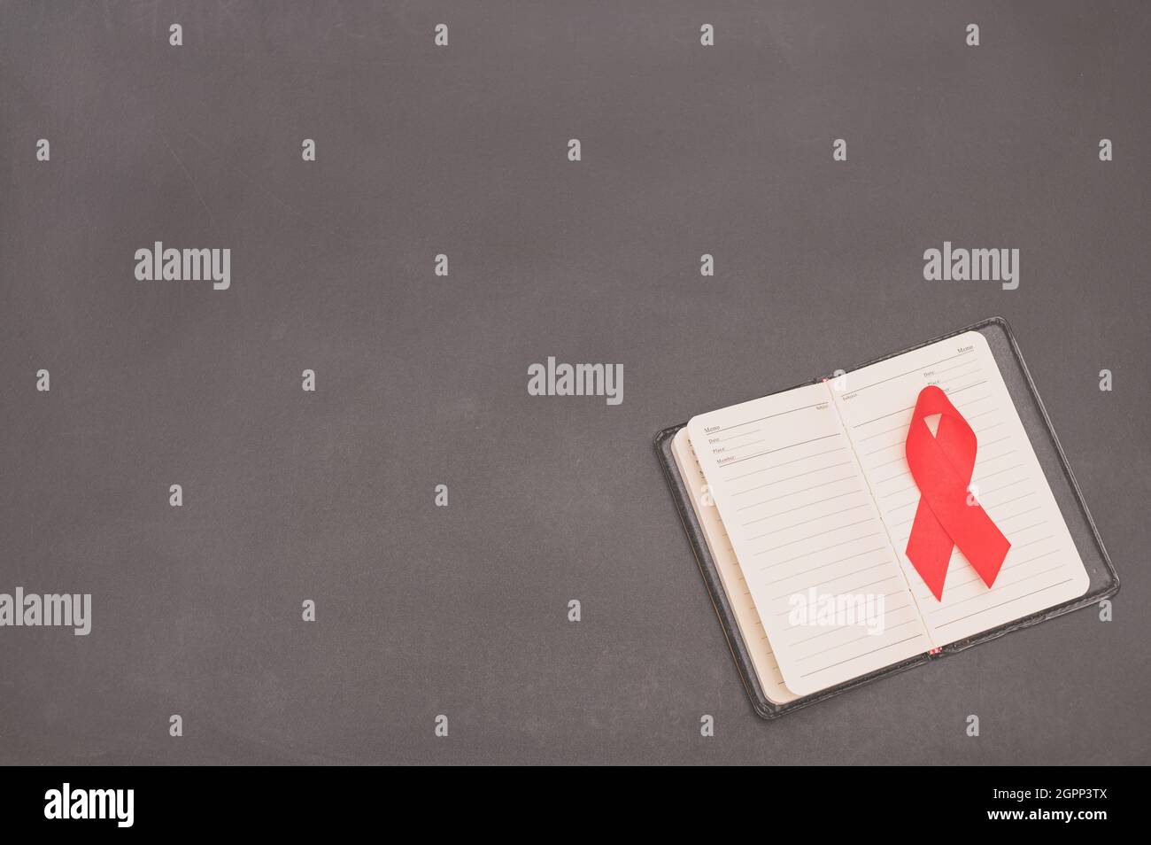 Red ribbon symbolizes world health day Stock Photo - Alamy