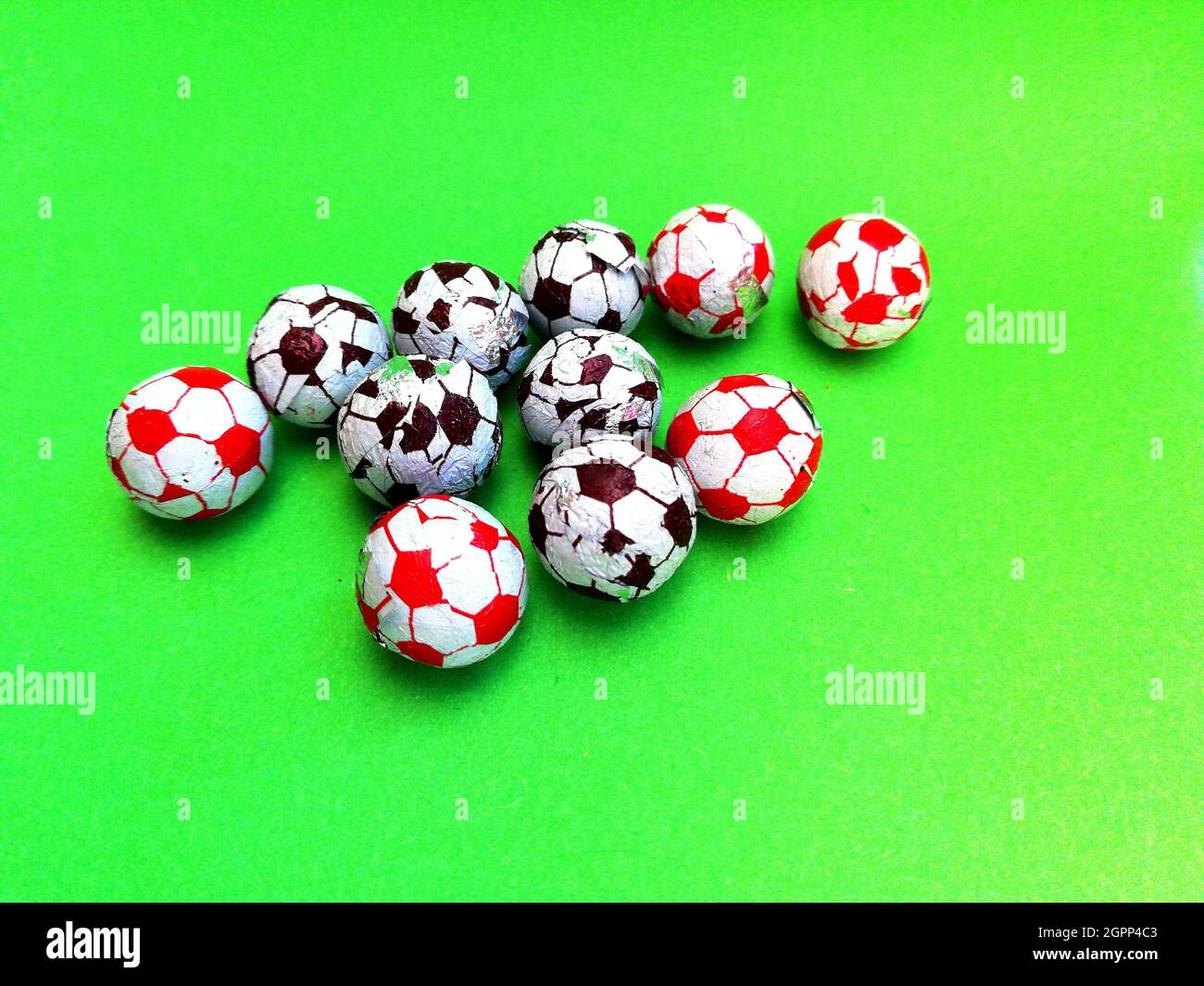 colored sweet balls group with green background Stock Photo - Alamy