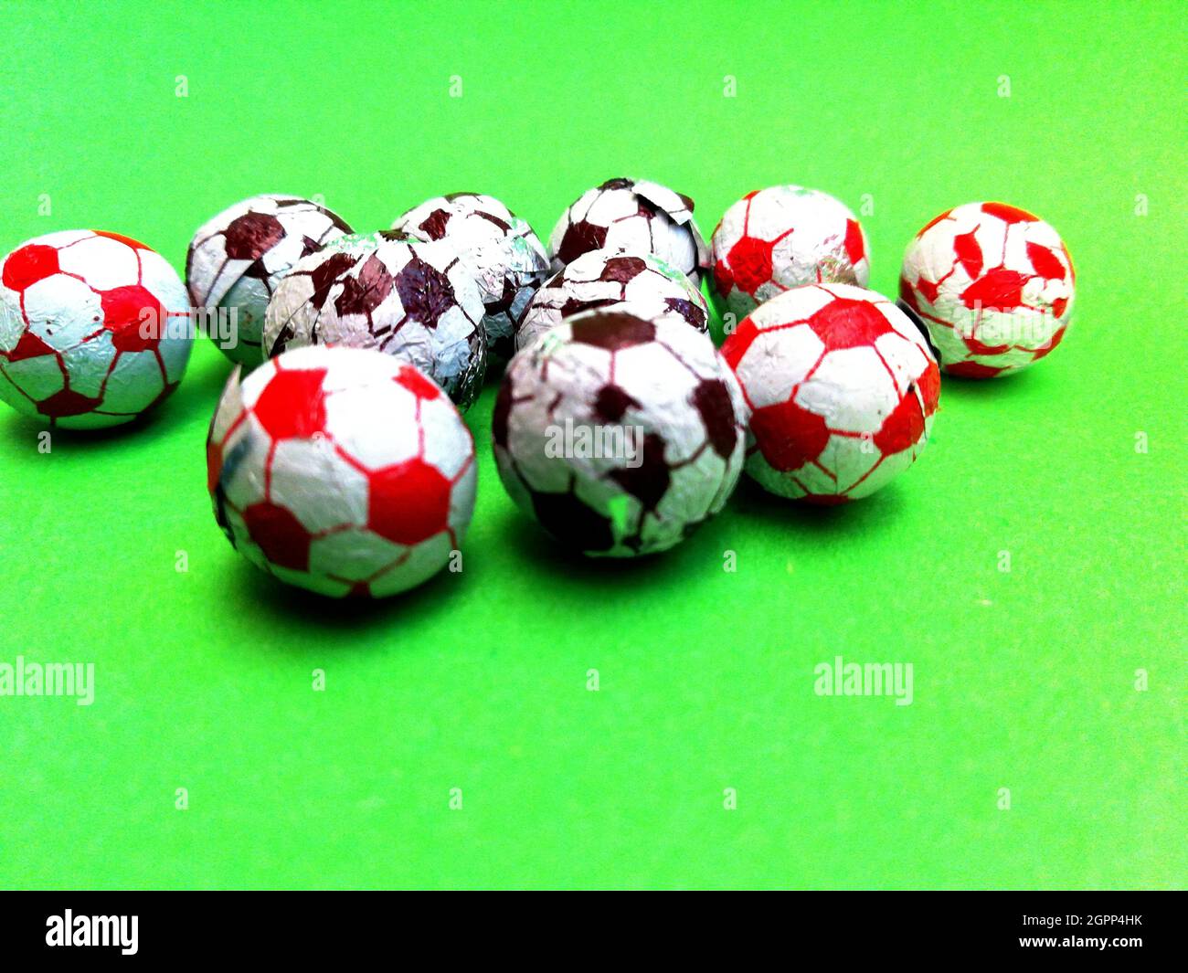 colored sweet balls group with green background Stock Photo - Alamy