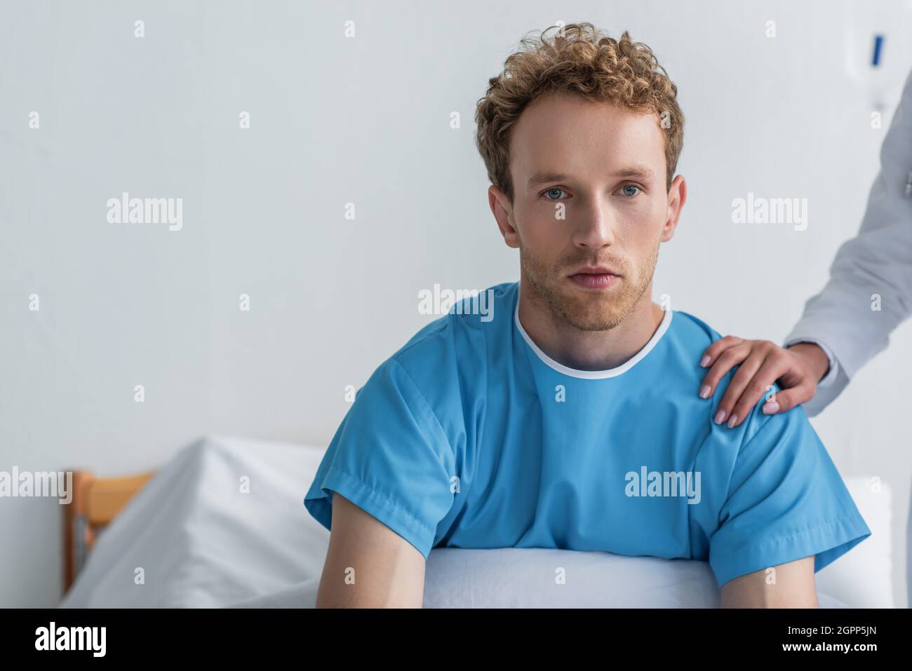 doctor in white coat and glasses calming sick and sad patient in ...