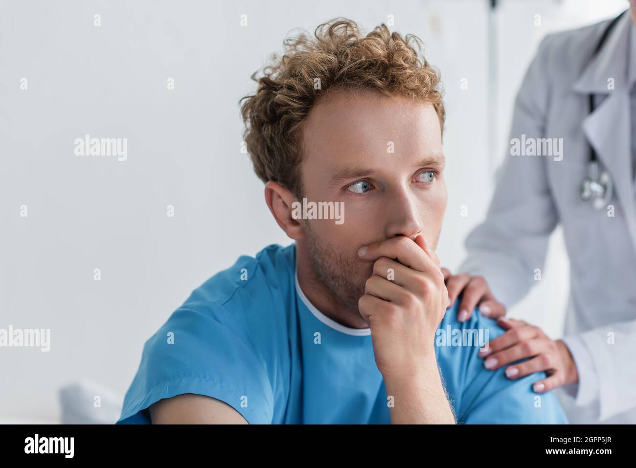 doctor in white coat calming sick and scared patient in hospital Stock ...