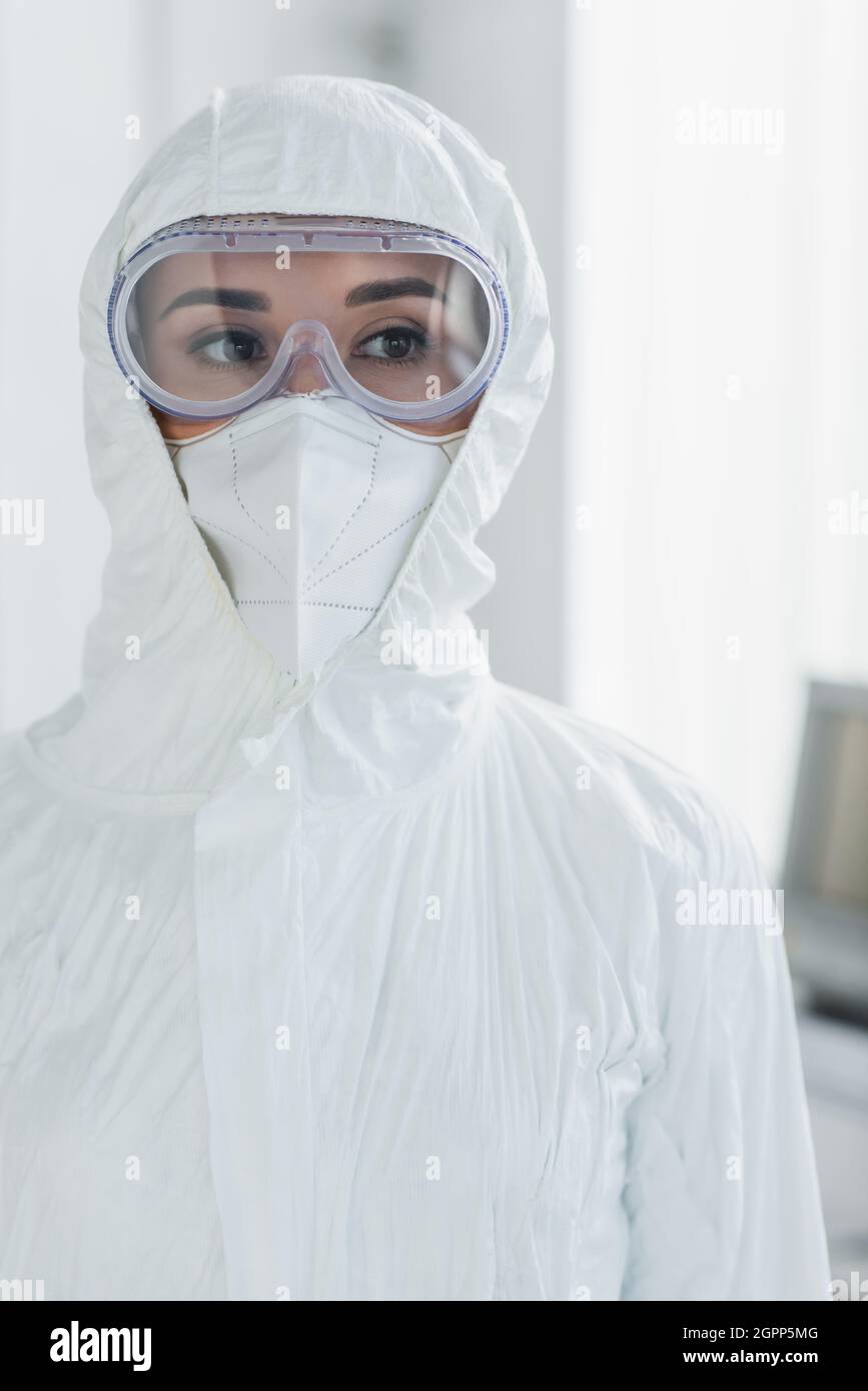 doctor in personal protective equipment and goggles looking away Stock ...