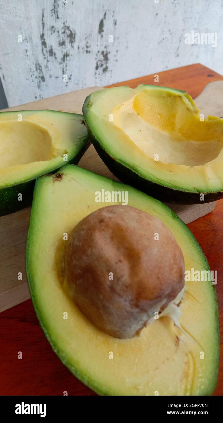 Photo of an avocado split into three parts Stock Photo - Alamy