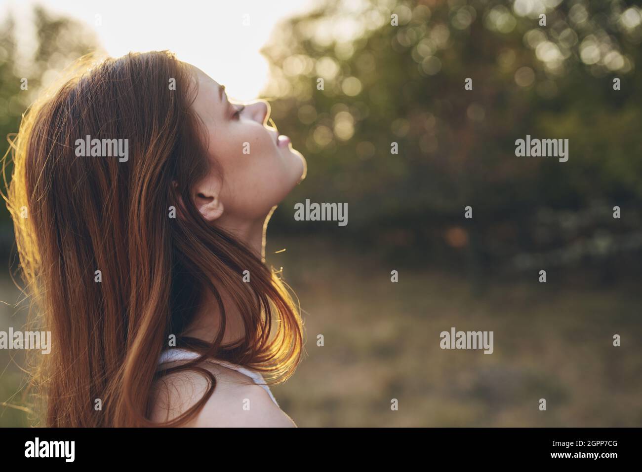 attractive woman in a field in nature sun freedom Stock Photo - Alamy