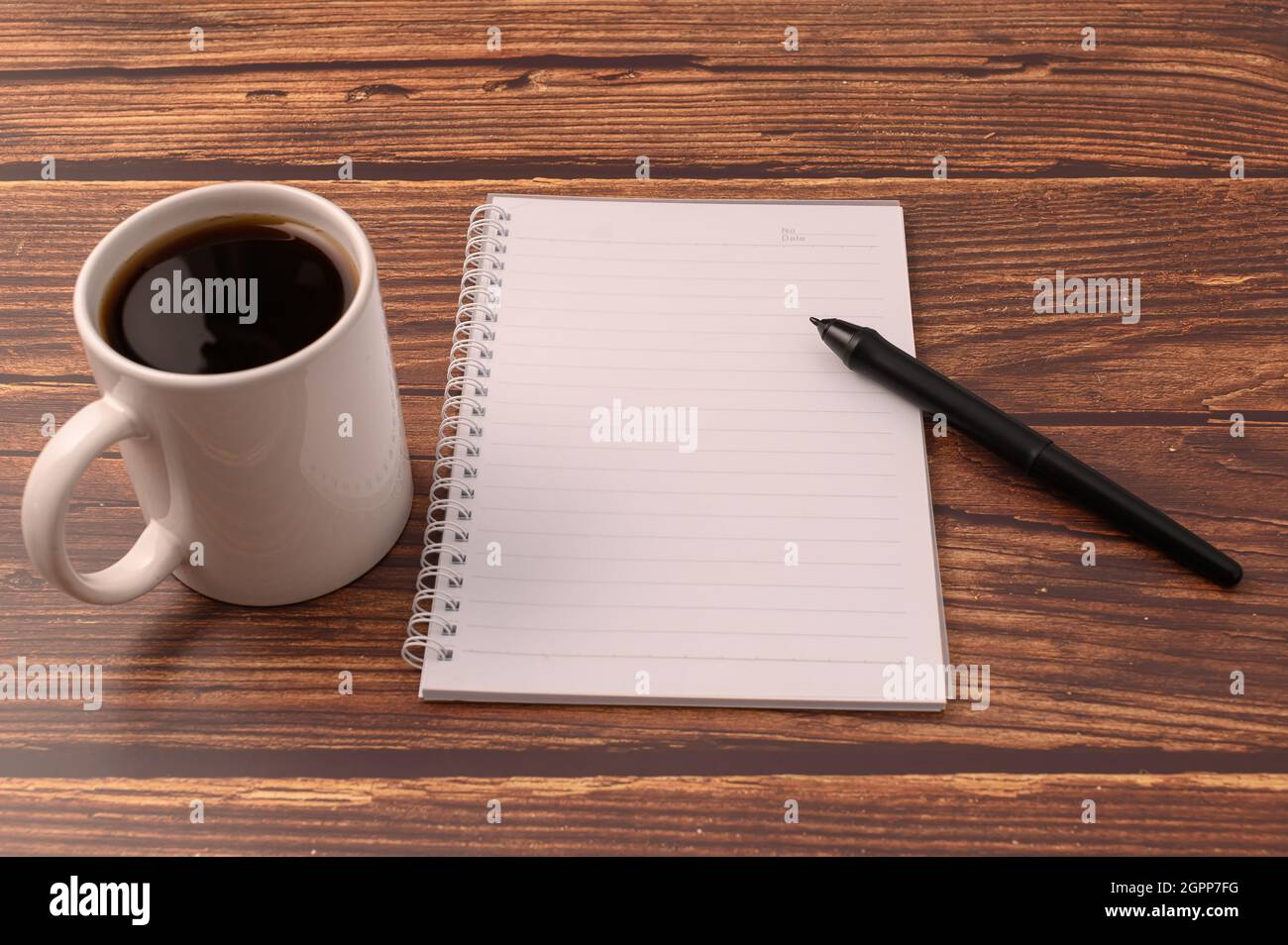 Coffee and a notebook are at your desk Stock Photo - Alamy