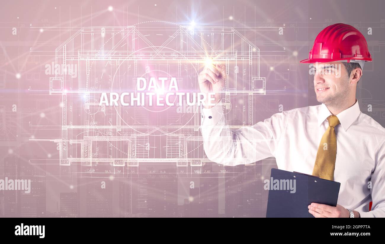 Handsome architect drawing with helmet Stock Photo - Alamy