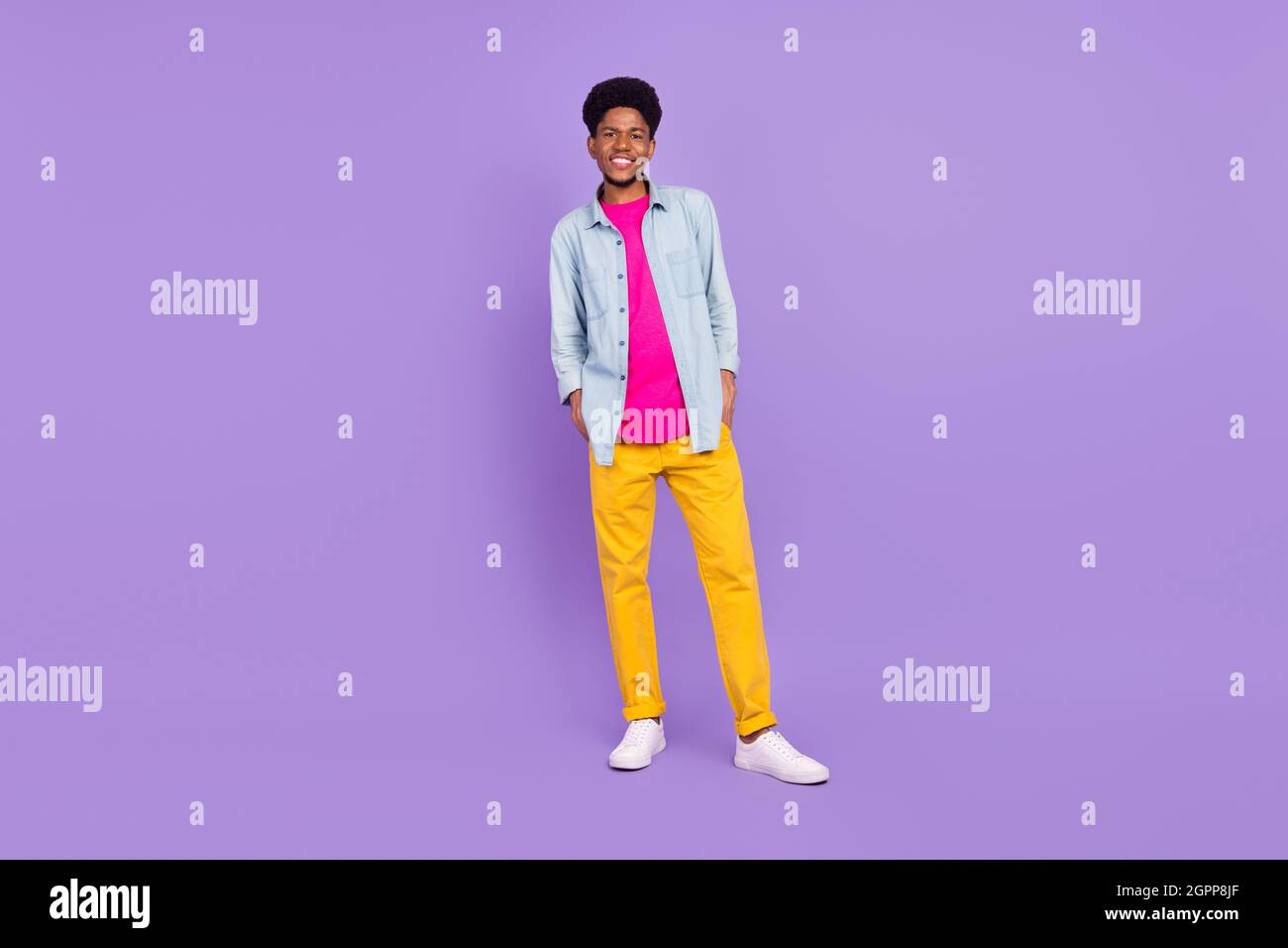 Photo of cute funny dark skin guy dressed jeans shirt arms pockets ...