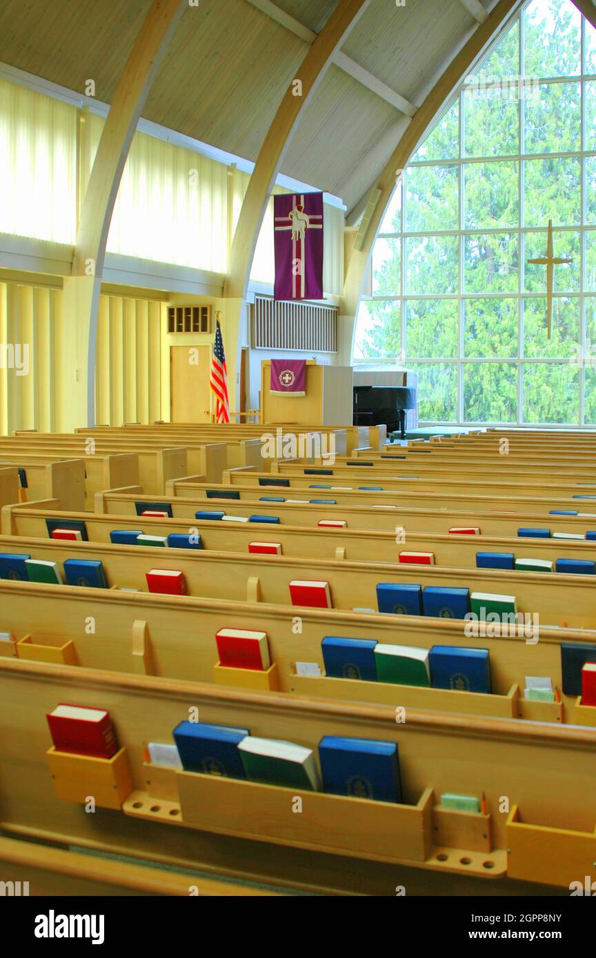 Serene view of the empty church seats with the holy bible books with ...