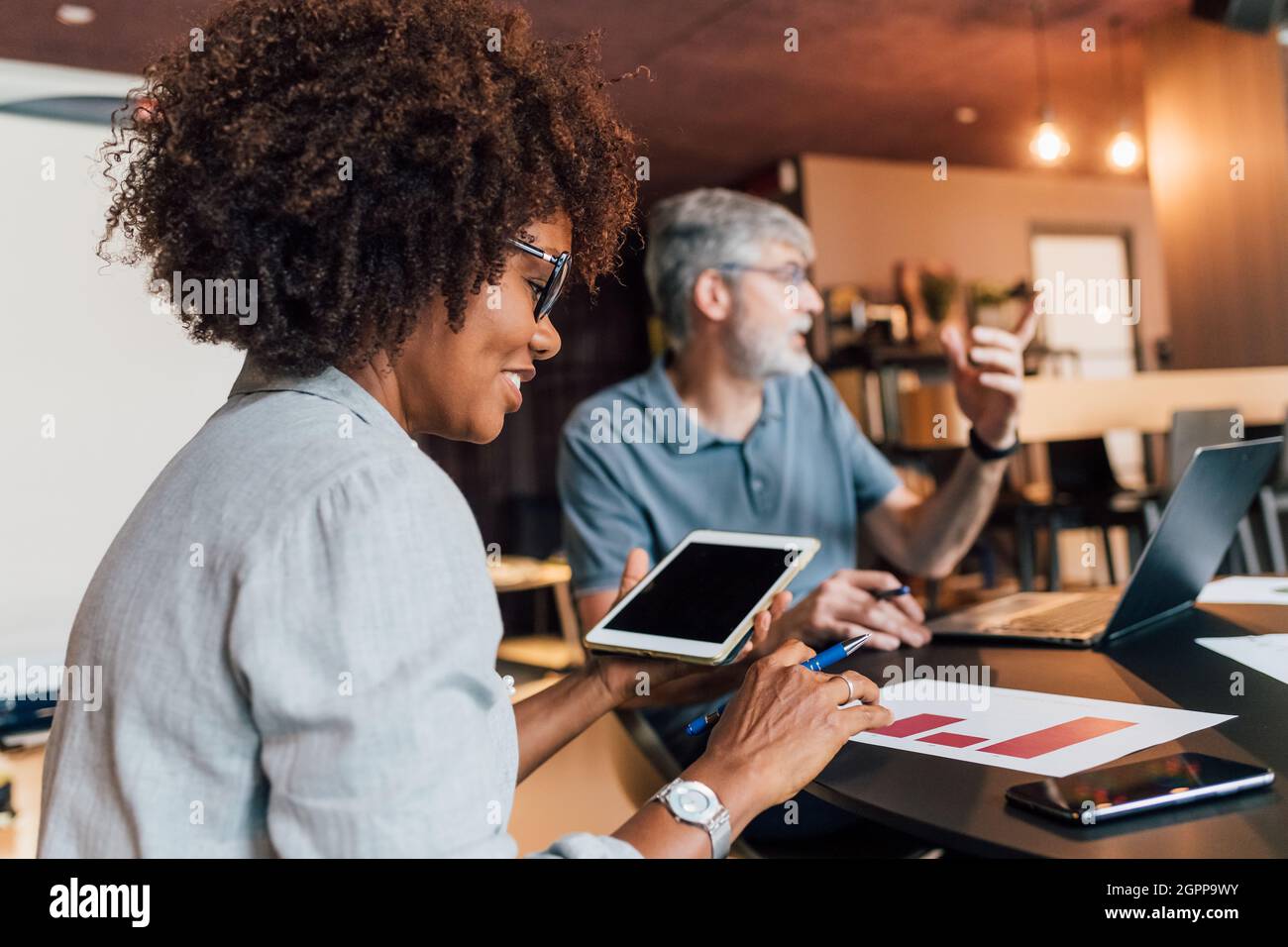 Italy, Business people having meeting in creative studio Stock Photo ...