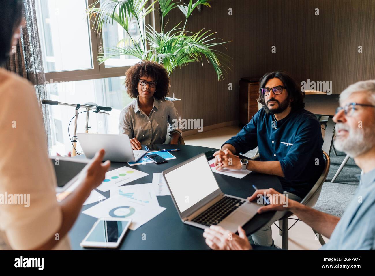 Italy, Business people having meeting in creative studio Stock Photo ...