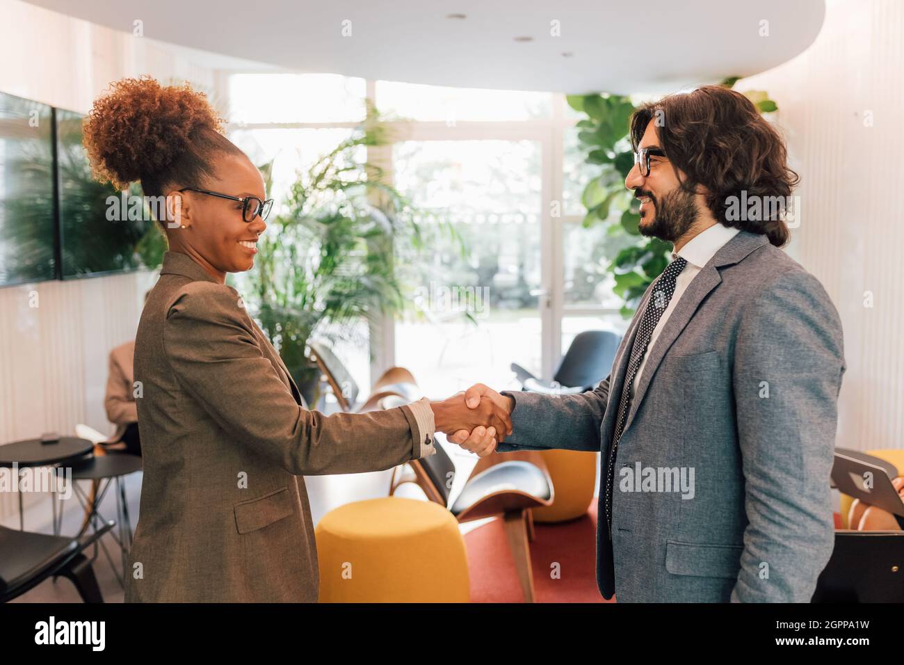 Standing smiling shaking hands face to face greeting leadership hi-res ...