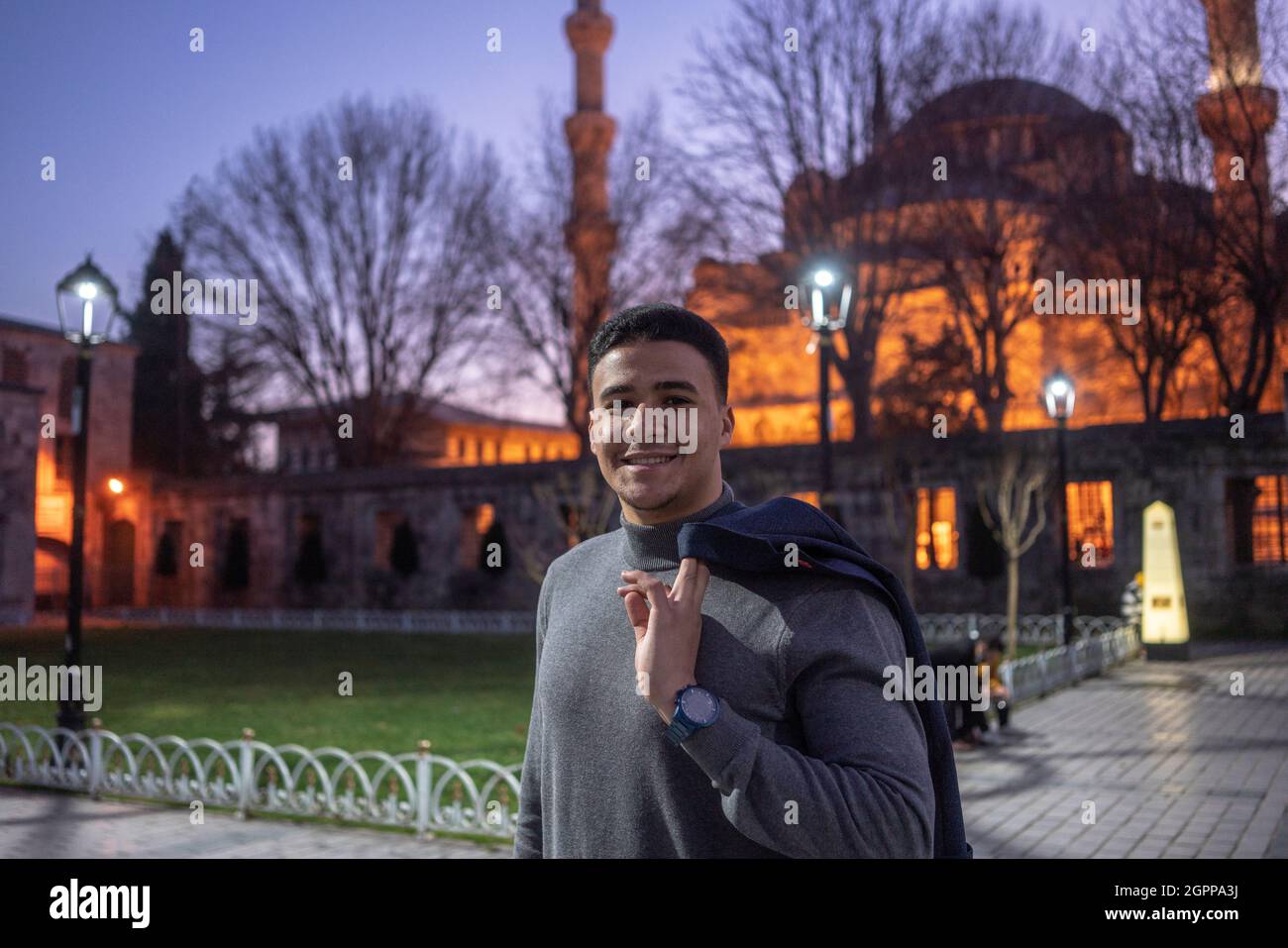 Turkey, Istanbul, Portrait of smiling man in front of Sultan Ahmet ...